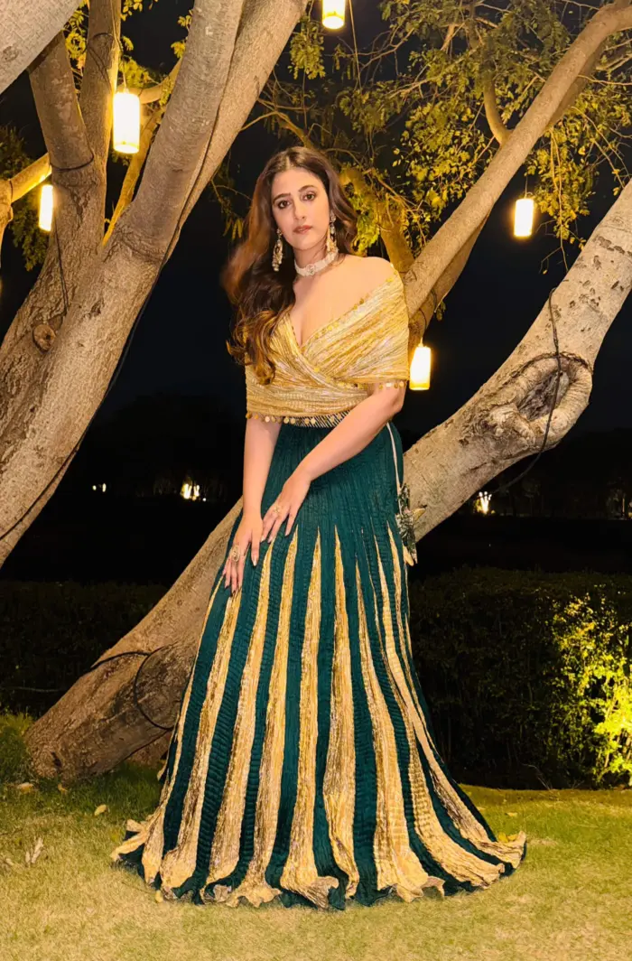 Nupur sanon in a bottle green and gold textured metallic lehenga and a ...